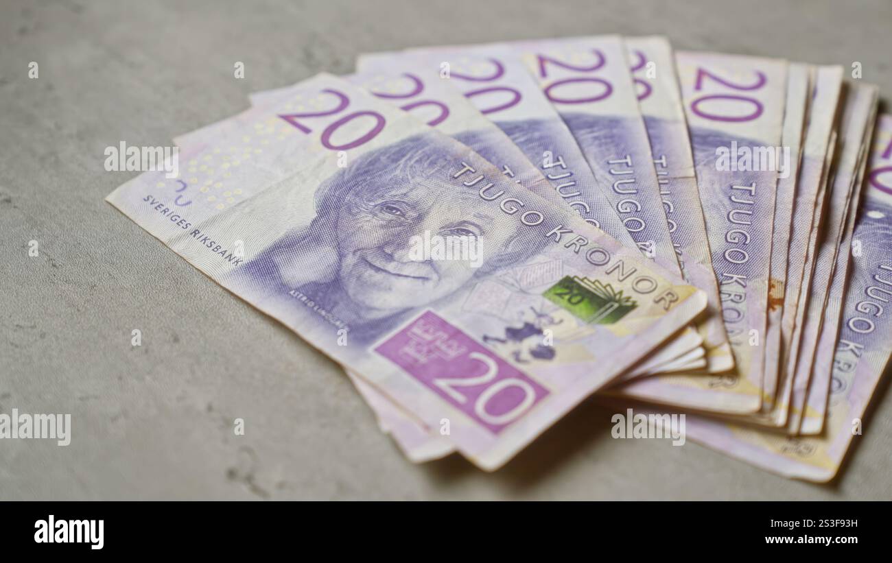 Swedish banknotes spread on a concrete surface, highlighting the detail ...