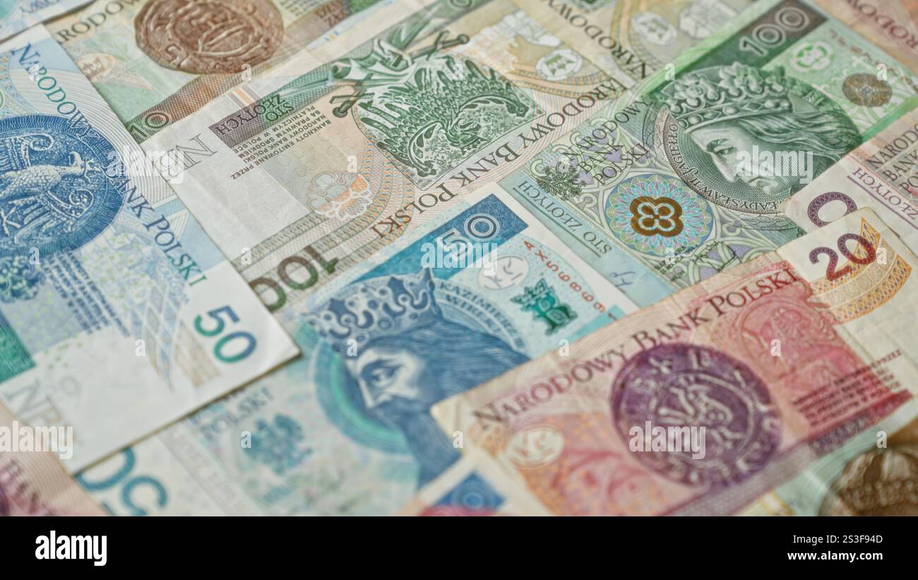 Polish zloty banknotes of various denominations spread out showcasing ...