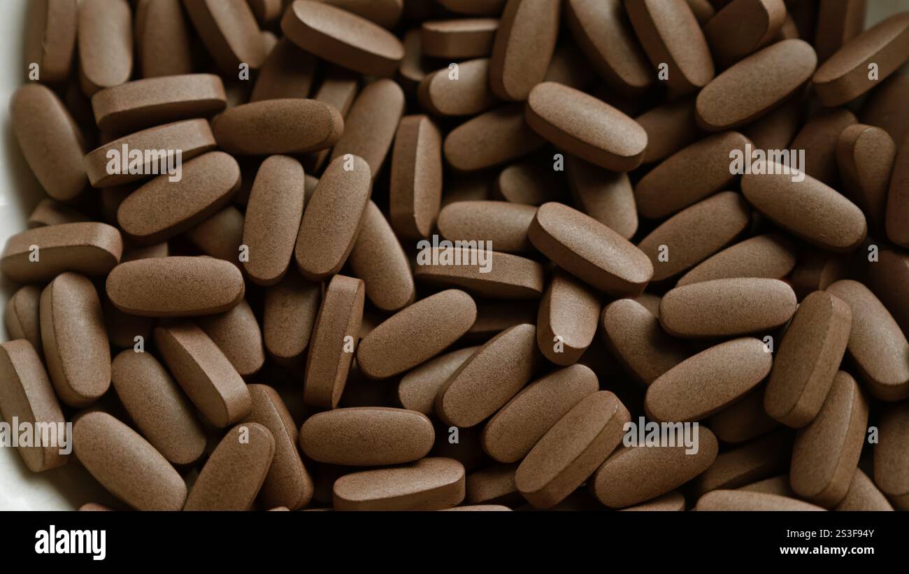 Numerous brown tablets scattered closely together provide a detailed ...