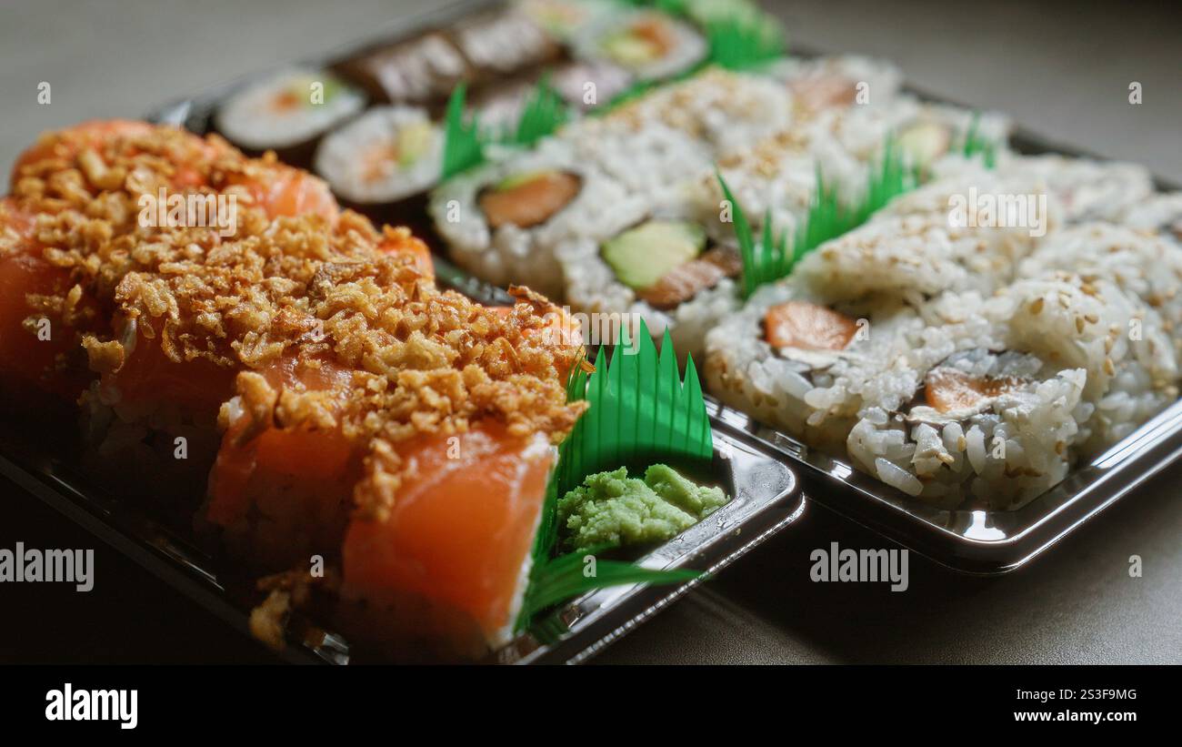 Delicious sushi tray with assorted rolls and garnishes showcasing fresh ...