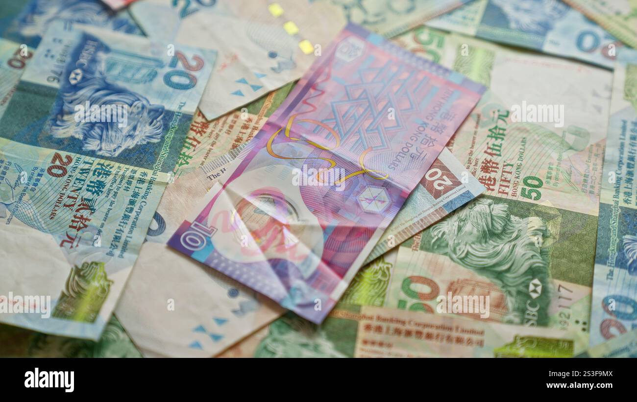 Colorful hong kong dollar banknotes scattered on a flat surface ...