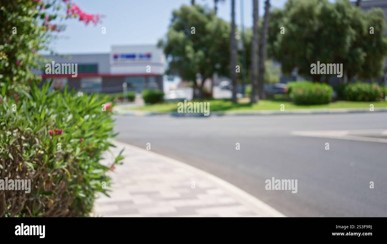 Defocused outdoor scene with a bokeh effect, showing a modern building ...