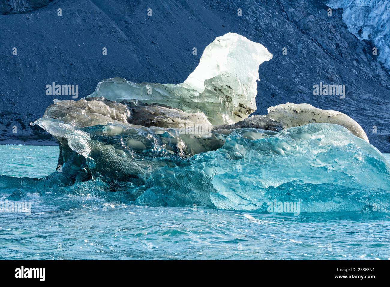 Close-up of a bizarre shaped iceberg floating close to a glacier at the ...