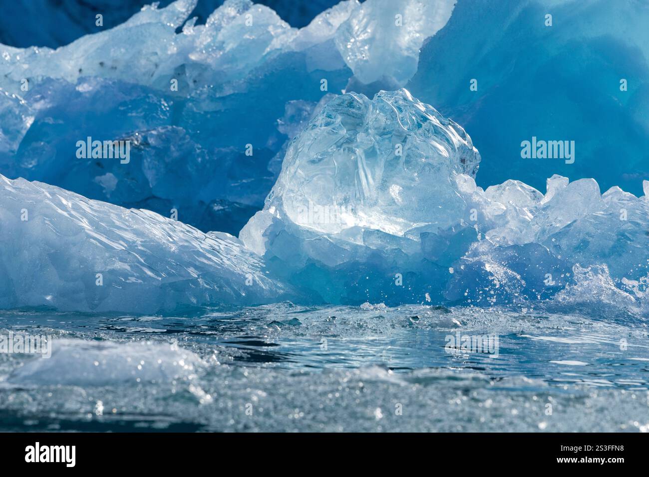 Close-up of glacial fragments of ice floating in seawater very close to ...