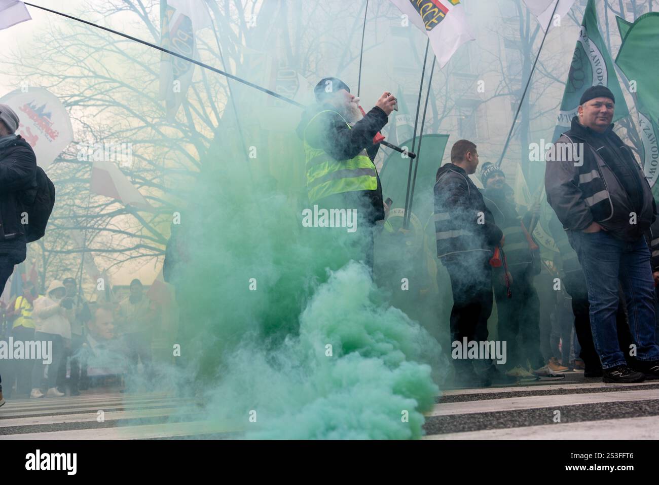 A man is surrounded by smoke from a flare during the rally. Thousands ...