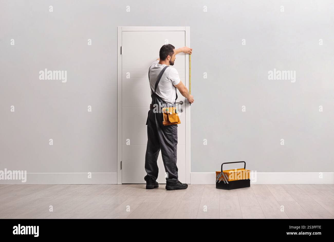 Builder in uniform measuring hi-res stock photography and images - Alamy