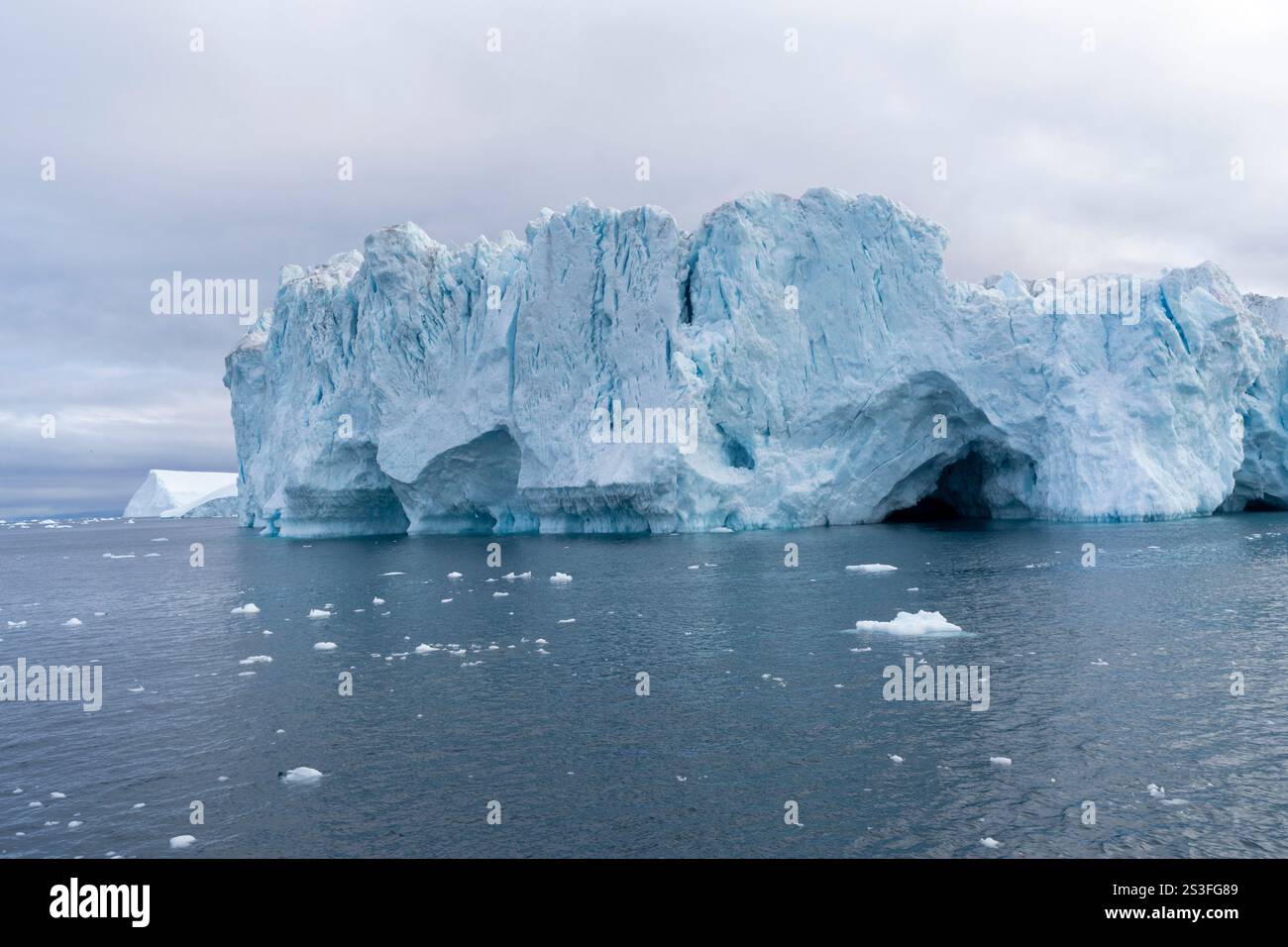 A huge, irregularly shaped iceberg floats in the UNESCO World Heritage ...