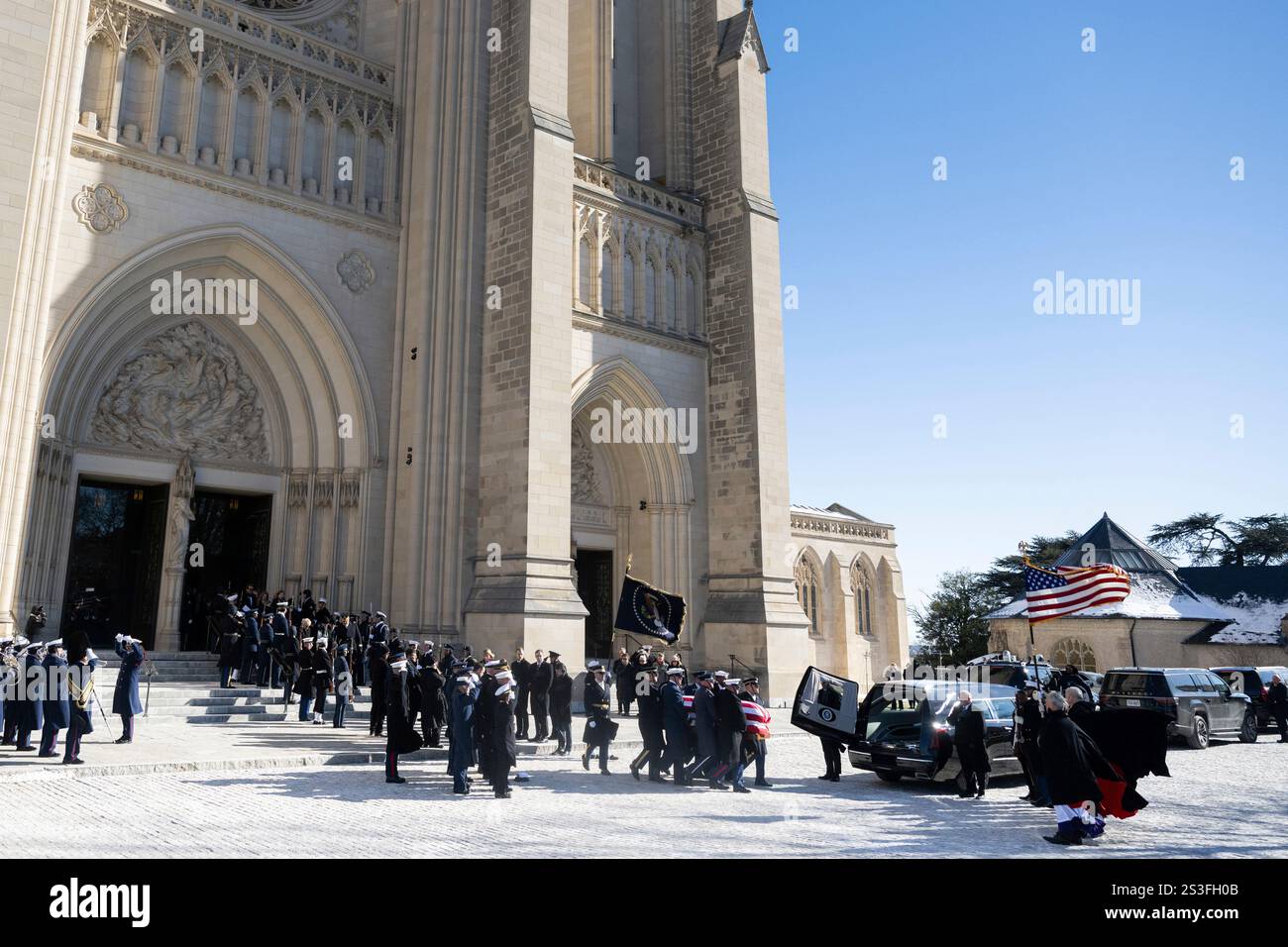 The flag-draped casket of former President Jimmy Carter is carried to a ...