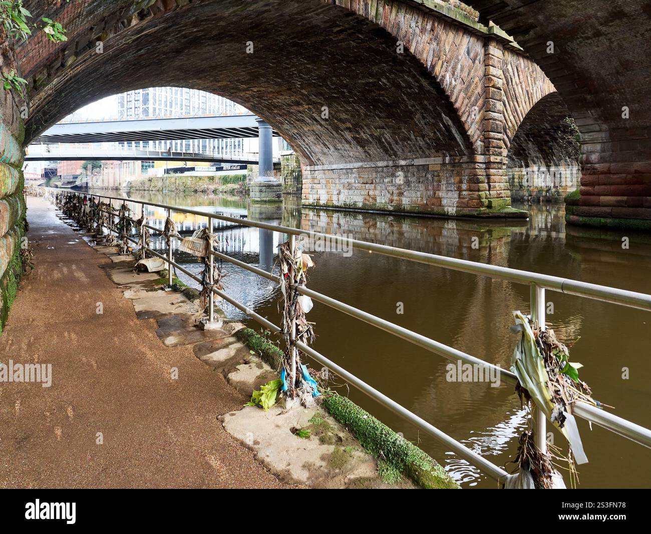 Salford, Manchester. Urban riverside path under stone bridge with ...