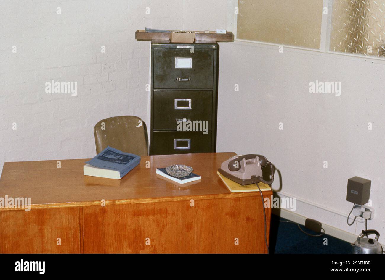 1978, picture shows a wooden desk inside an office of a light ...