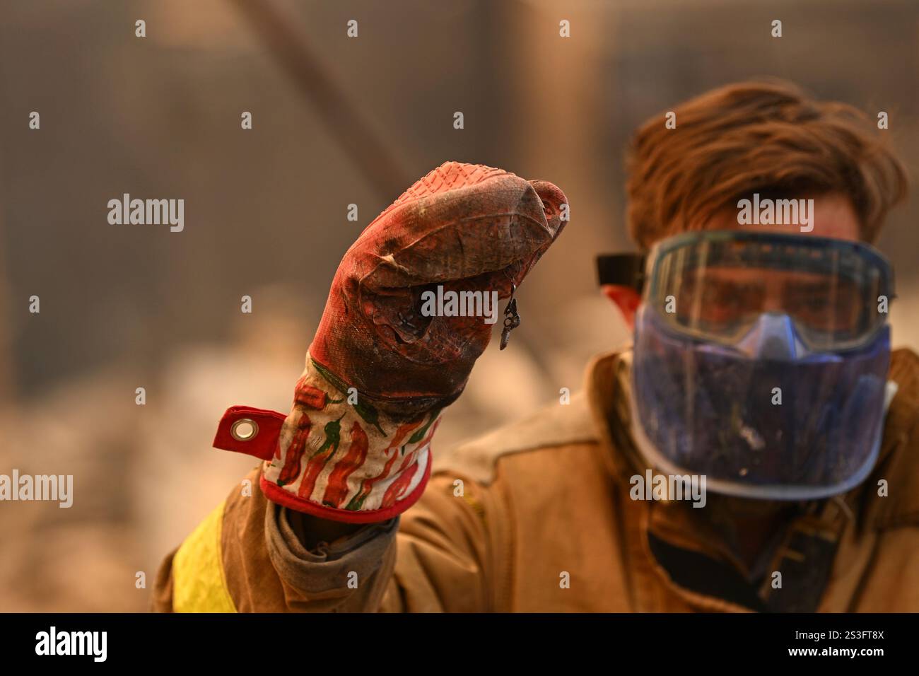 Robert Lara holds up one of his great grandmother's burned earrings at ...