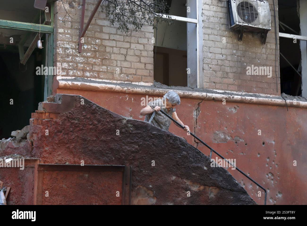 Destroyed apartment building after rocket attack. Traces of fragments Stock Photo - Alamy