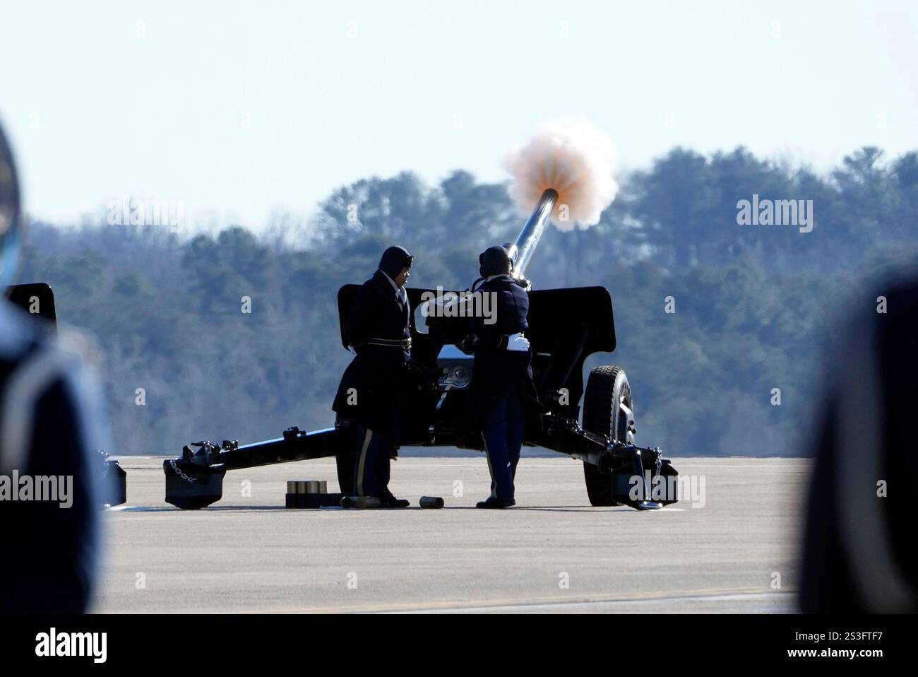 A 21-gun salute is rendered before fhe flag-draped casket of former ...