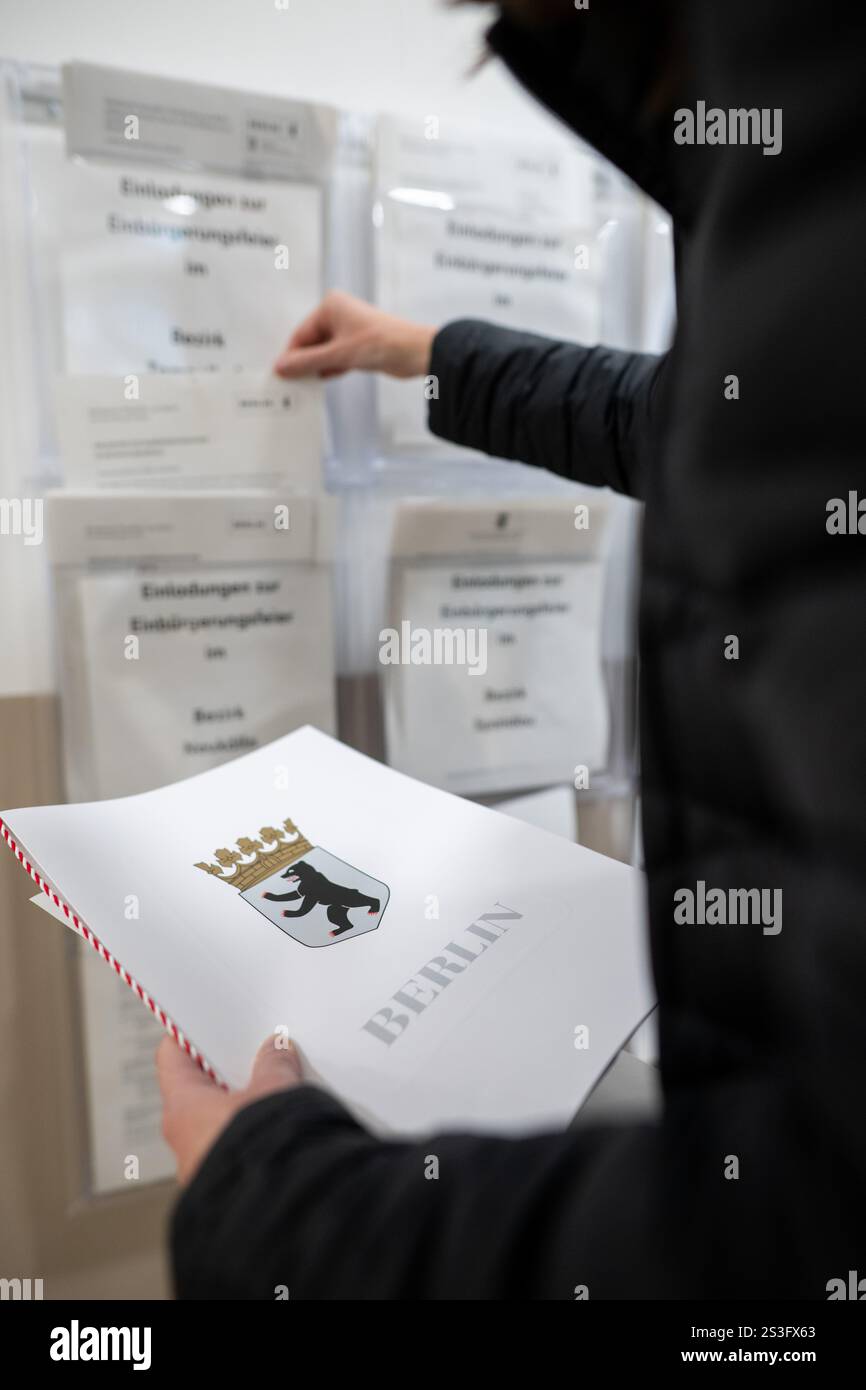 Berlin, Germany. 08th Jan, 2025. A woman takes an invitation to a ...
