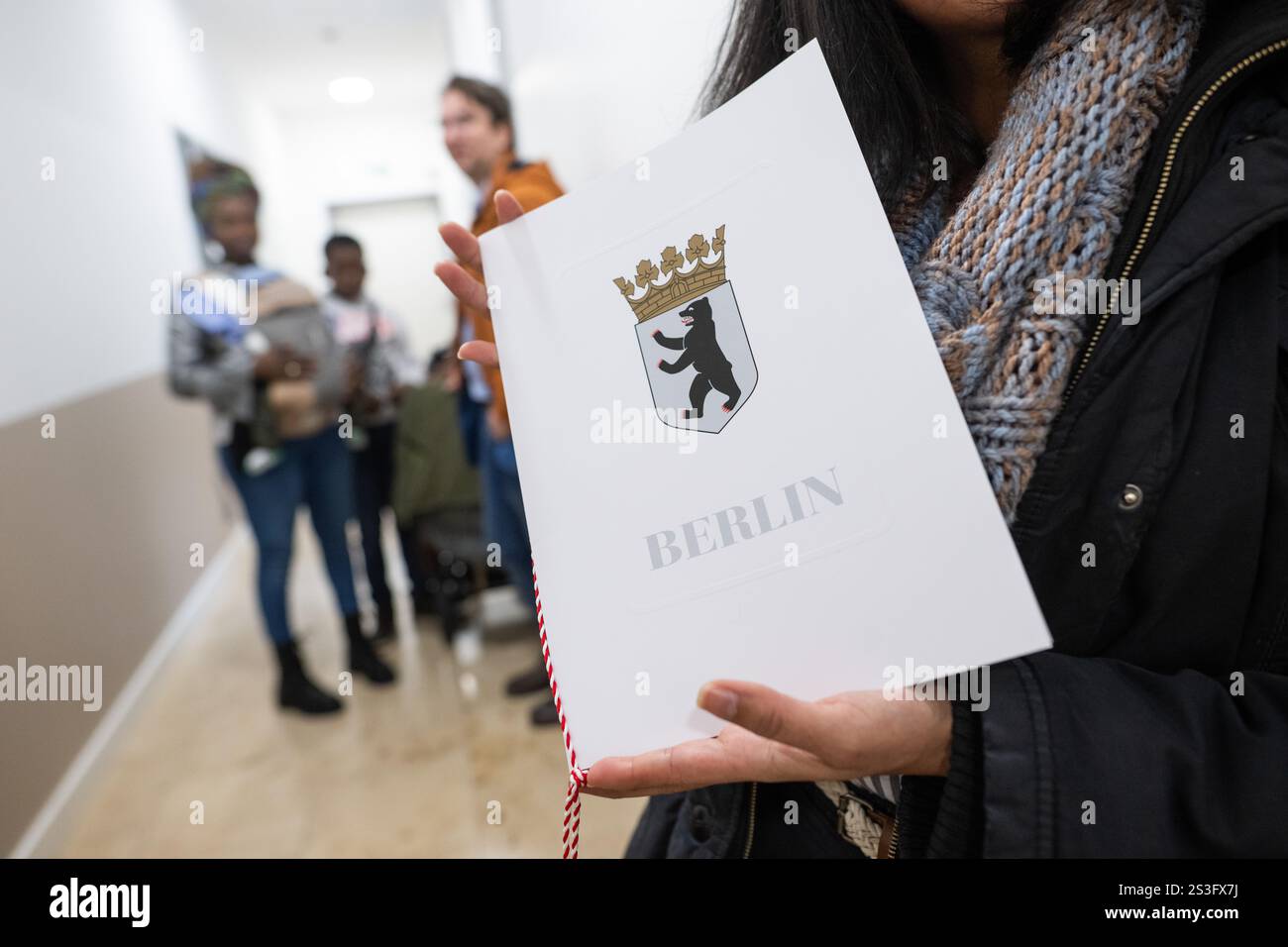 Berlin, Germany. 08th Jan, 2025. A woman shows her naturalization ...