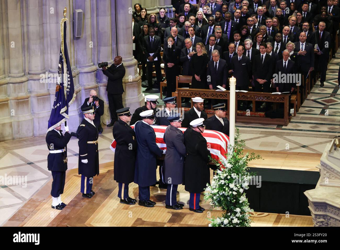 A coffin carrying former President Jimmy Carter is covered in the ...