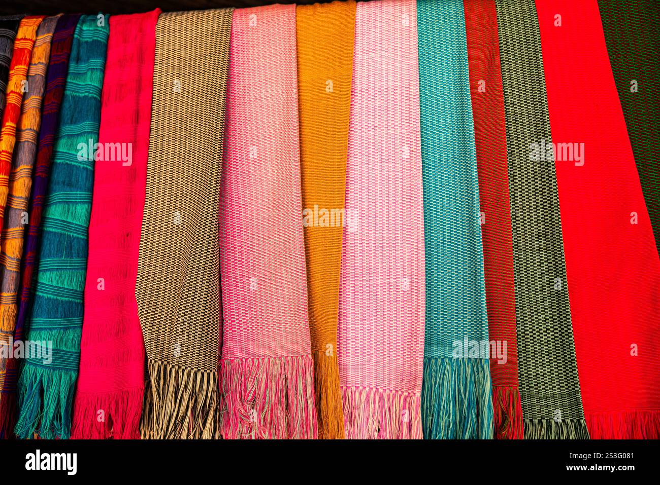 A vibrant display of traditional handwoven fabrics featuring an array ...