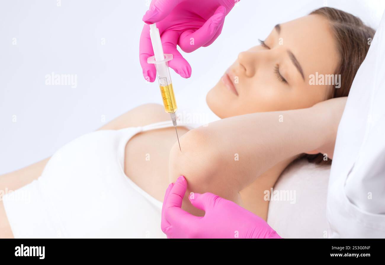 Doctor doing stem cell therapy on a patient's elbow after the injury. Treating knee pain with ...