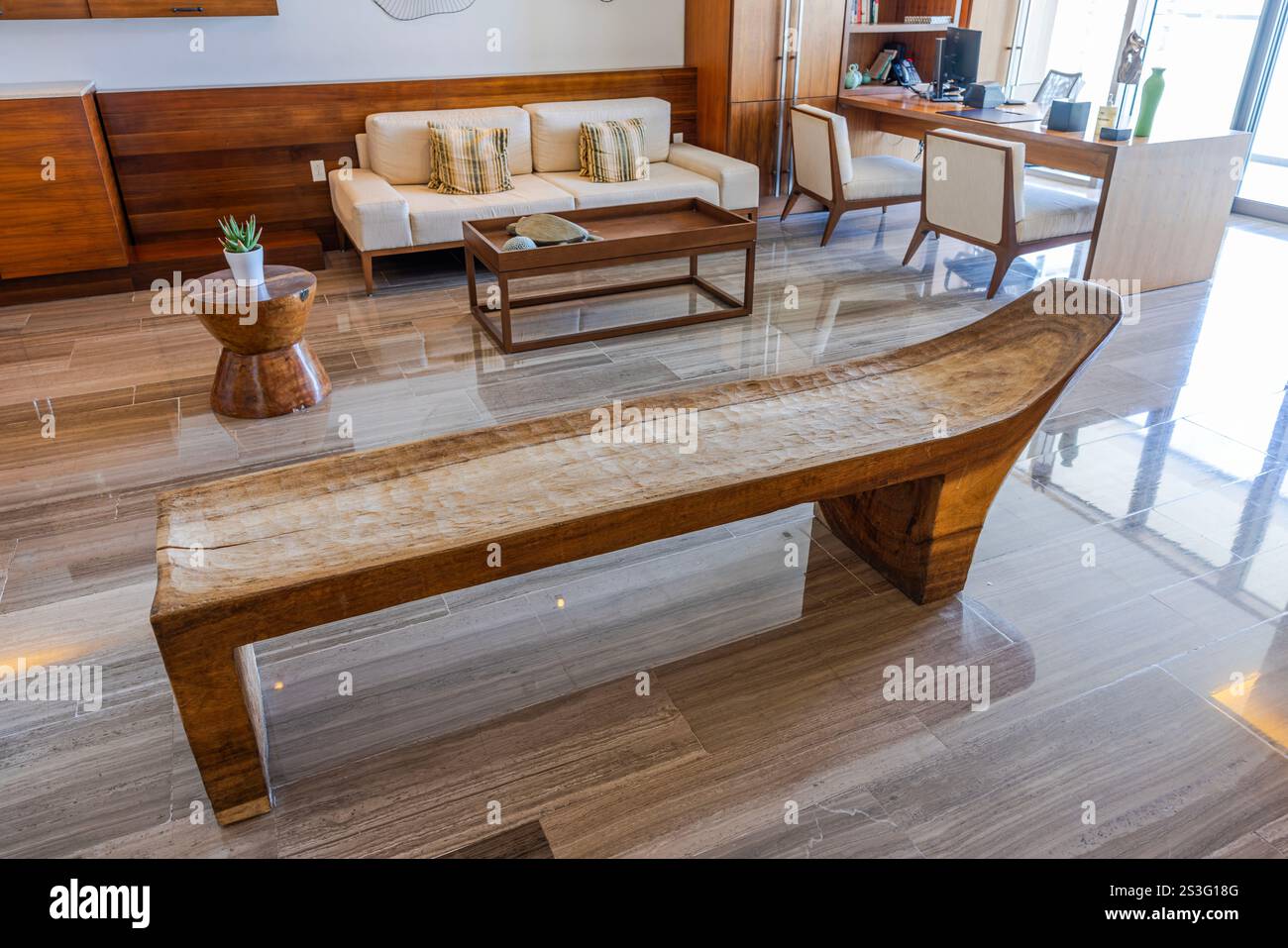 Modern hotel lobby interior with wooden bench, table and sofa ...