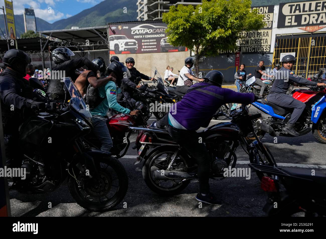 Police and government supporters surround opponents of Venezuelan ...