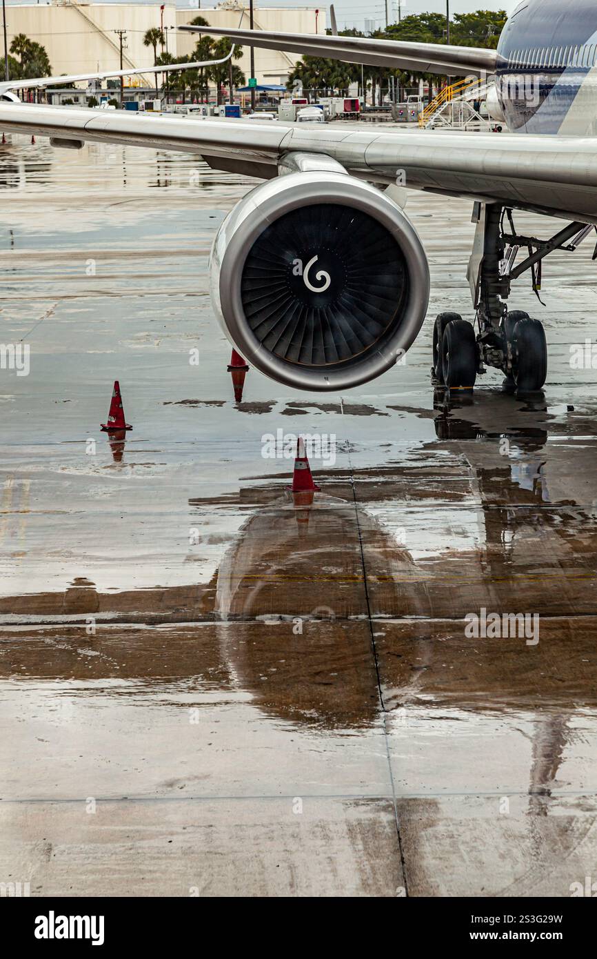 turbine with reflection in water at the apron of a passenger aircraft ...