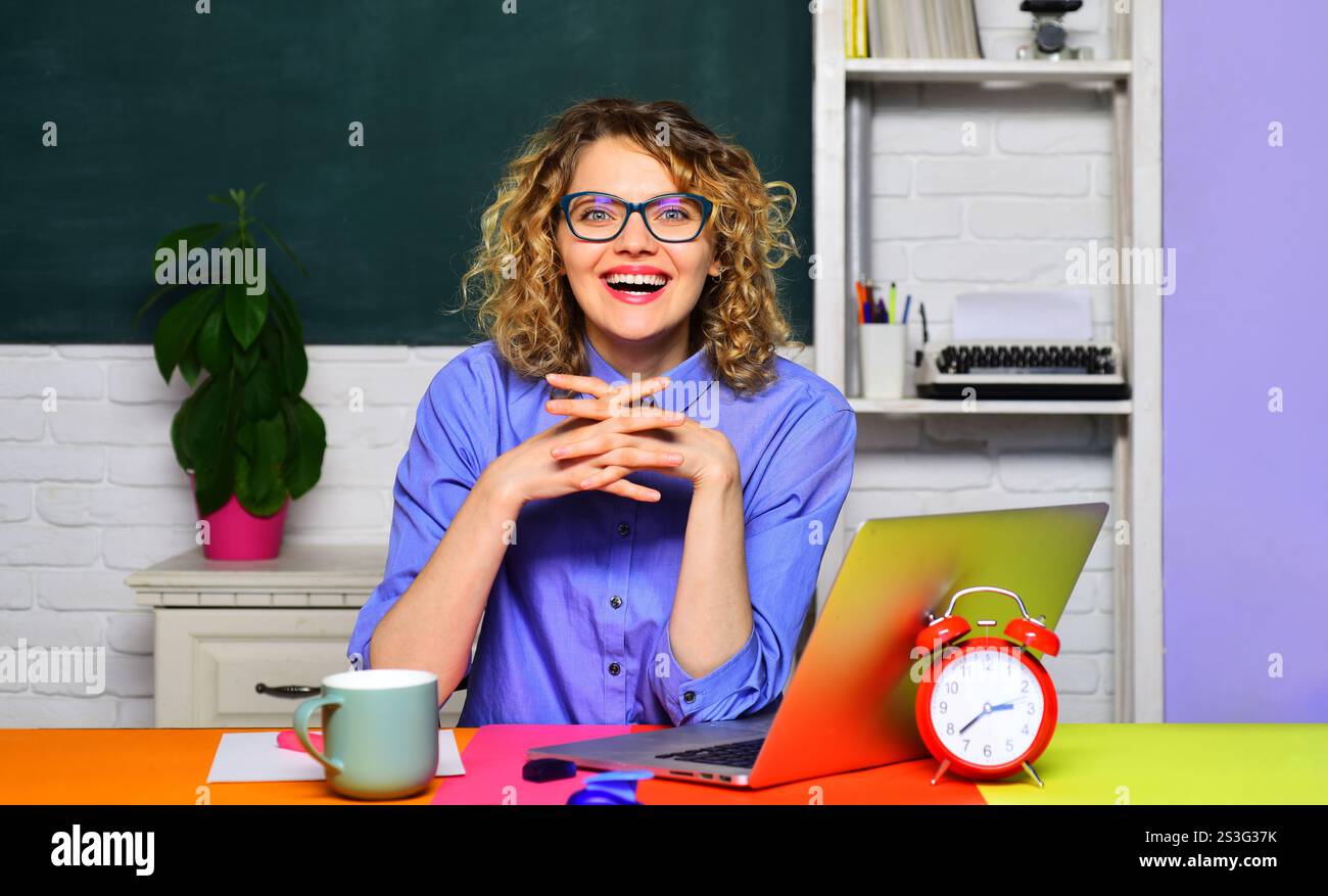Teacher or university professor sitting at desk in classroom having ...