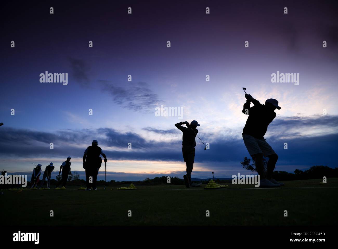 Anonymous golfers hitting balls Stock Photo - Alamy