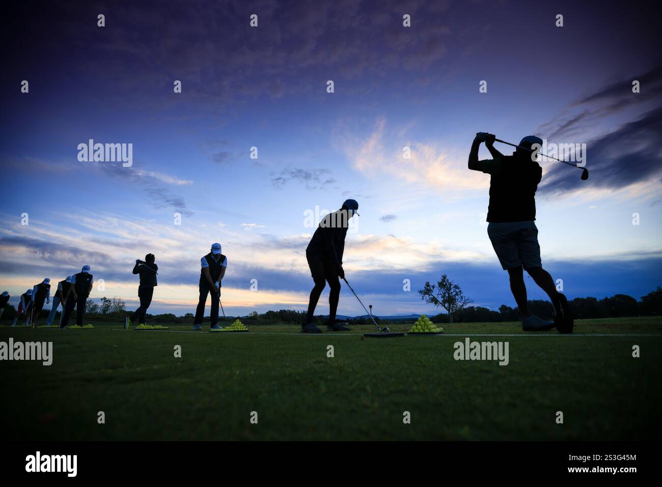 Anonymous golfers hitting balls Stock Photo - Alamy