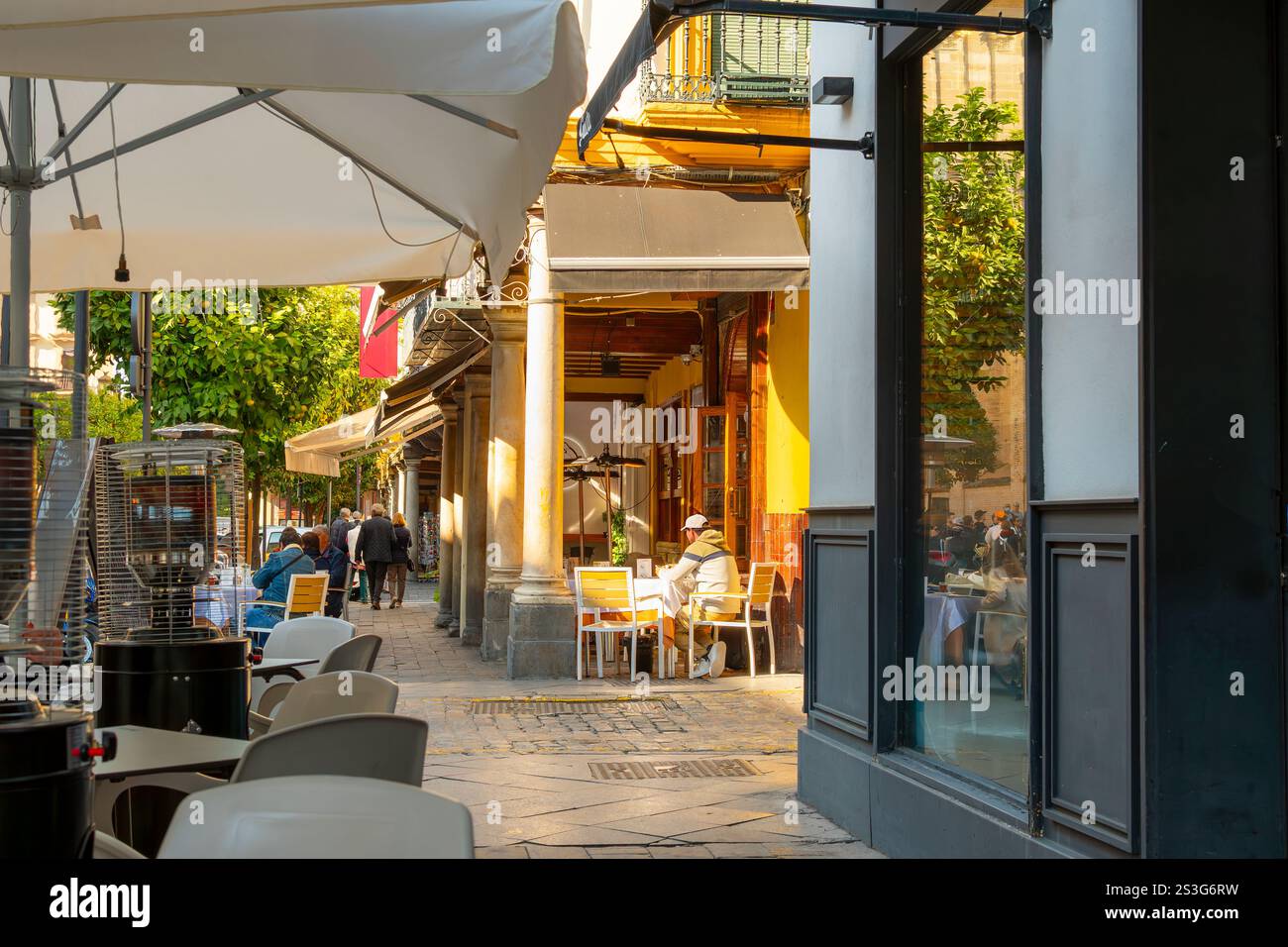 A sidewalk full of shops and sidewalk cafes in the historic Barrio ...