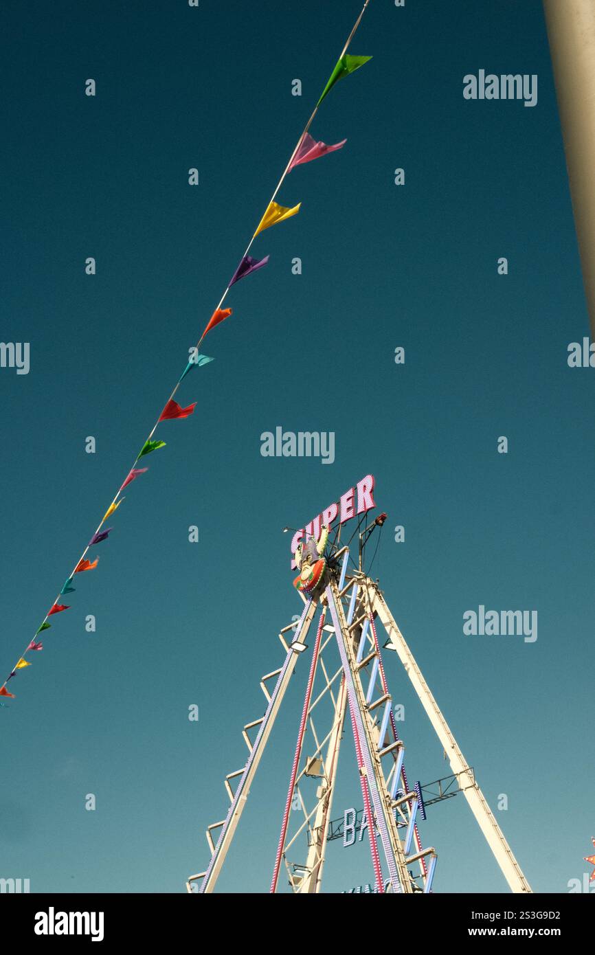 Vintage-style photo of a retro amusement park attraction under a bright ...