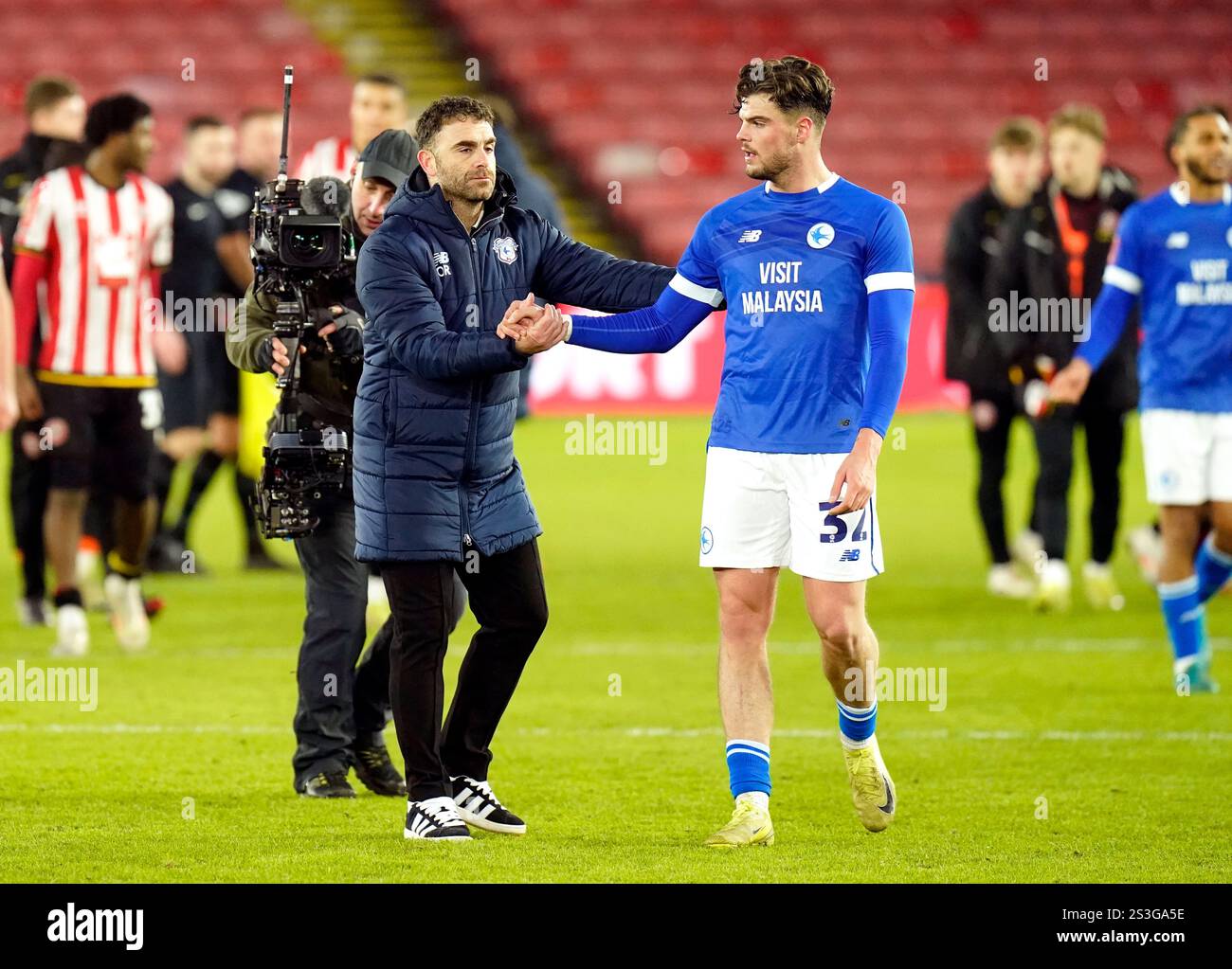 Cardiff City manager Omer Riza greets Ollie Tanner following the ...