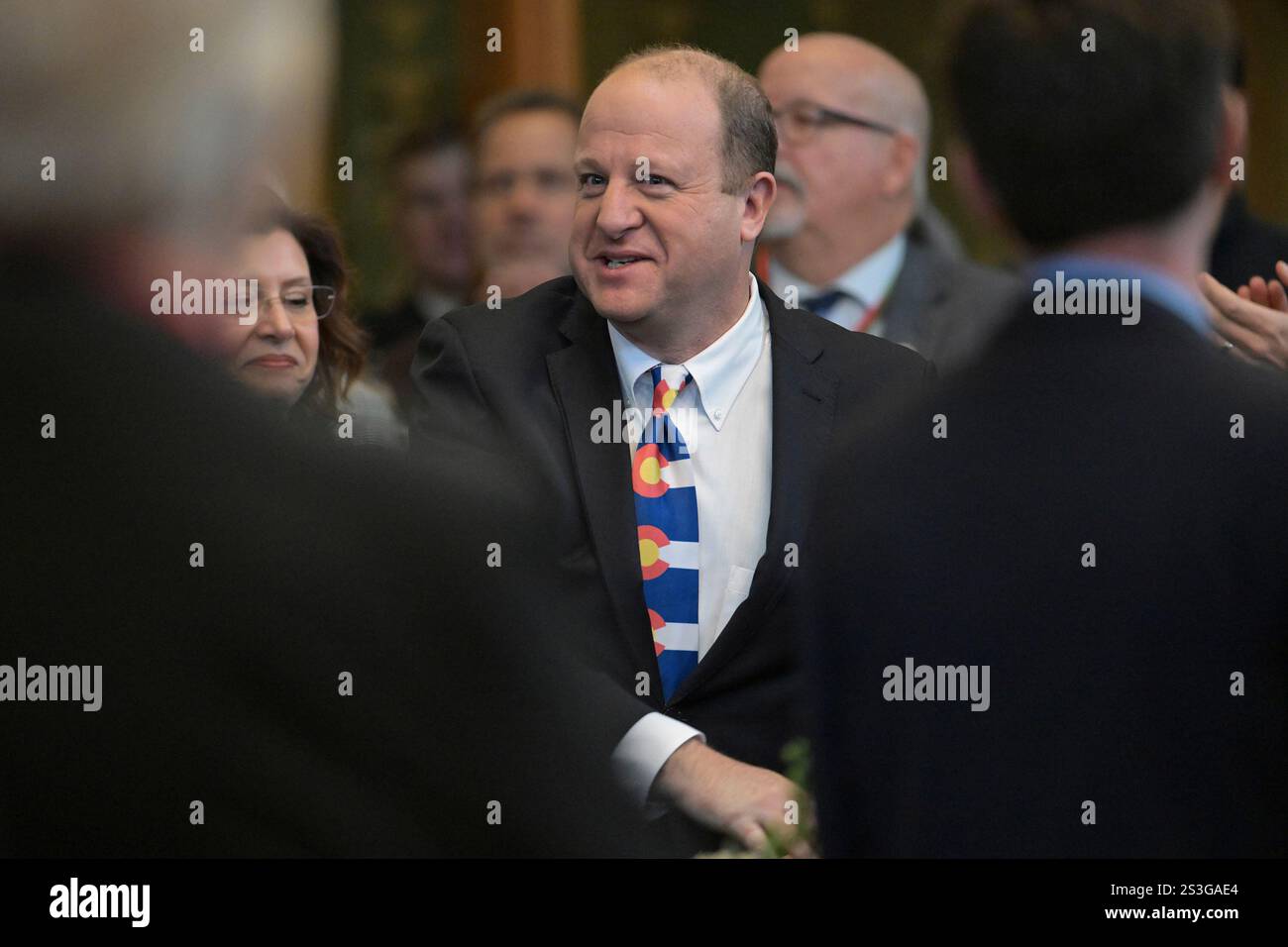 Colorado Gov. Jared Polis arrives in the House chamber of the Colorado ...