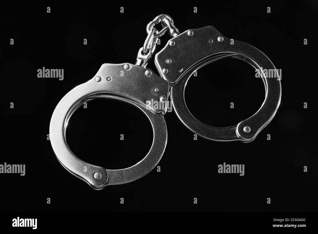 Metal chain handcuffs on black background, closeup Stock Photo - Alamy