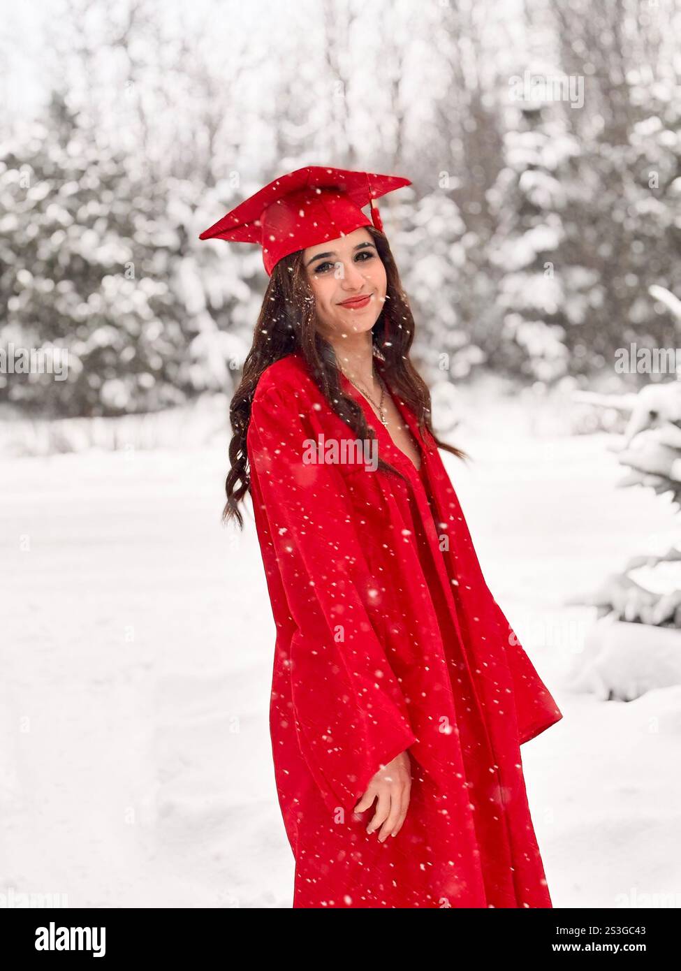 Graduating girl with long brunette hair wearing red cap, and graduation ...
