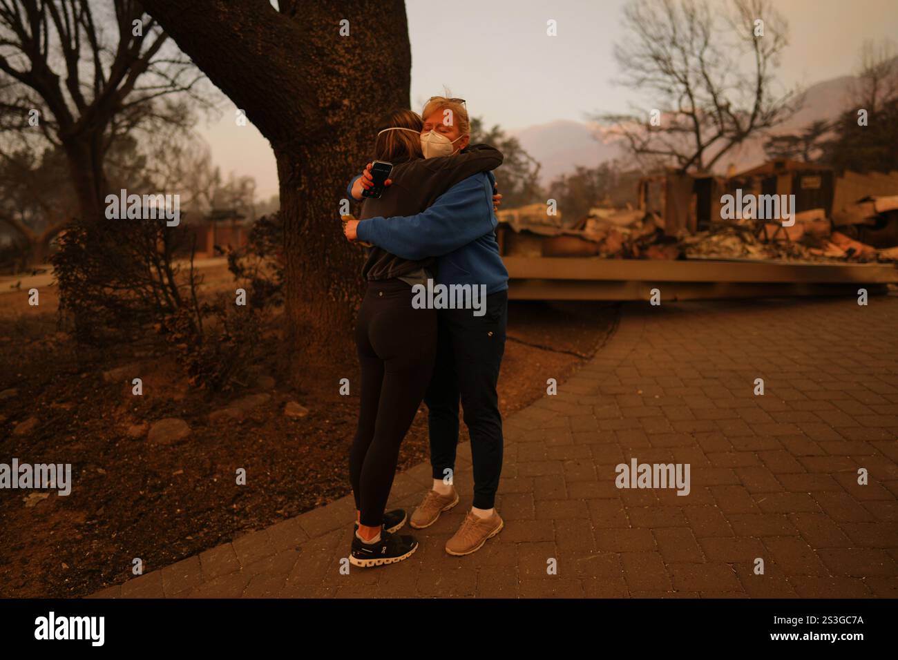 Melissa Young, center right, gets hug from a well-wisher at her fire ...