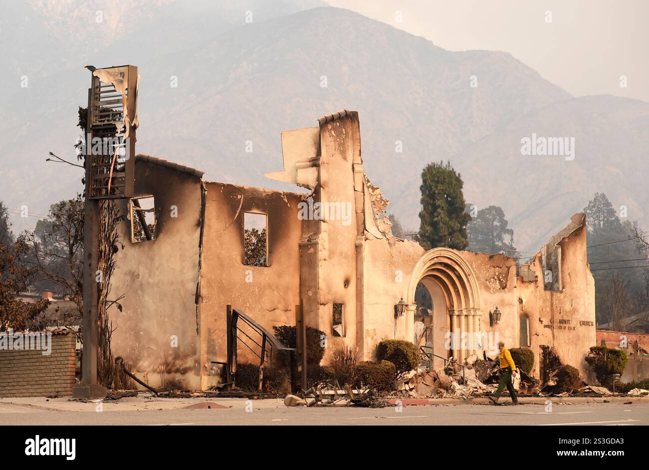 A man walks past the charred remains of the Altadena Community Church ...