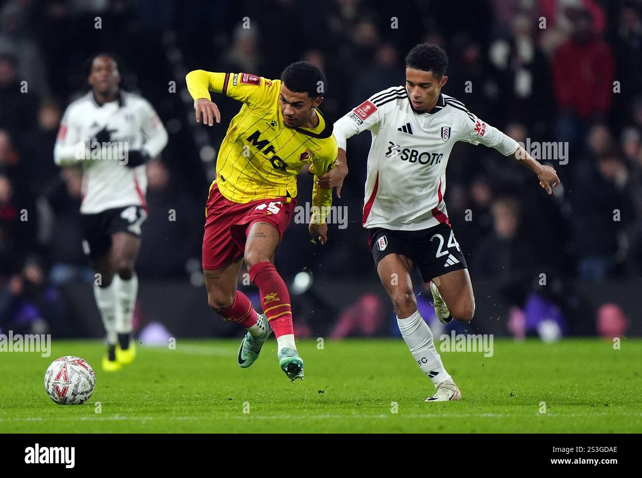 Watford's Ryan Andrews and Fulham's Josh King (right) battle for the ...