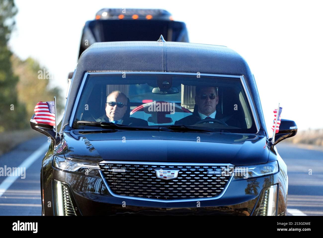 The hearse containing the flag-draped casket of former President Jimmy ...