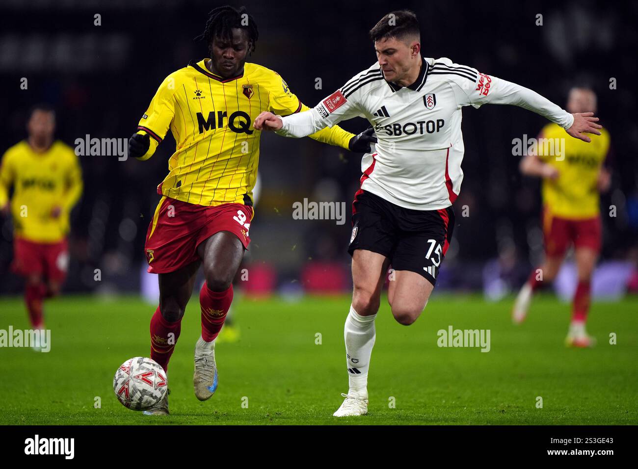 Watford's Kwadwo Baah and Fulham's Jorge Cuenca (right) battle for the ...