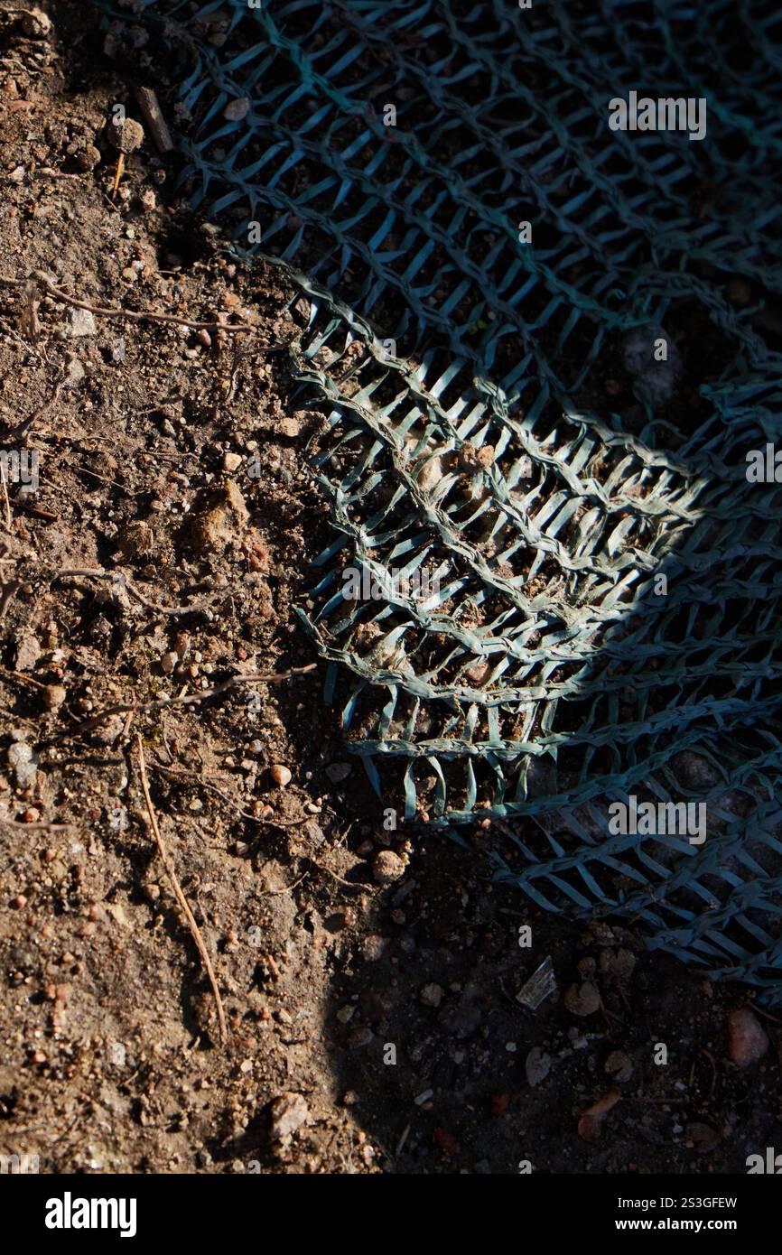 A Detailed CloseUp View of the Ground Featuring Mesh Netting Alongside ...