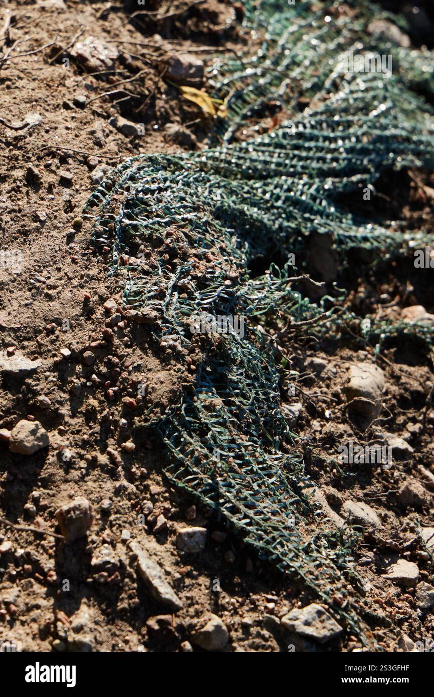 Discarded Fishing Net on the Ground, Highlighting Pollution and ...