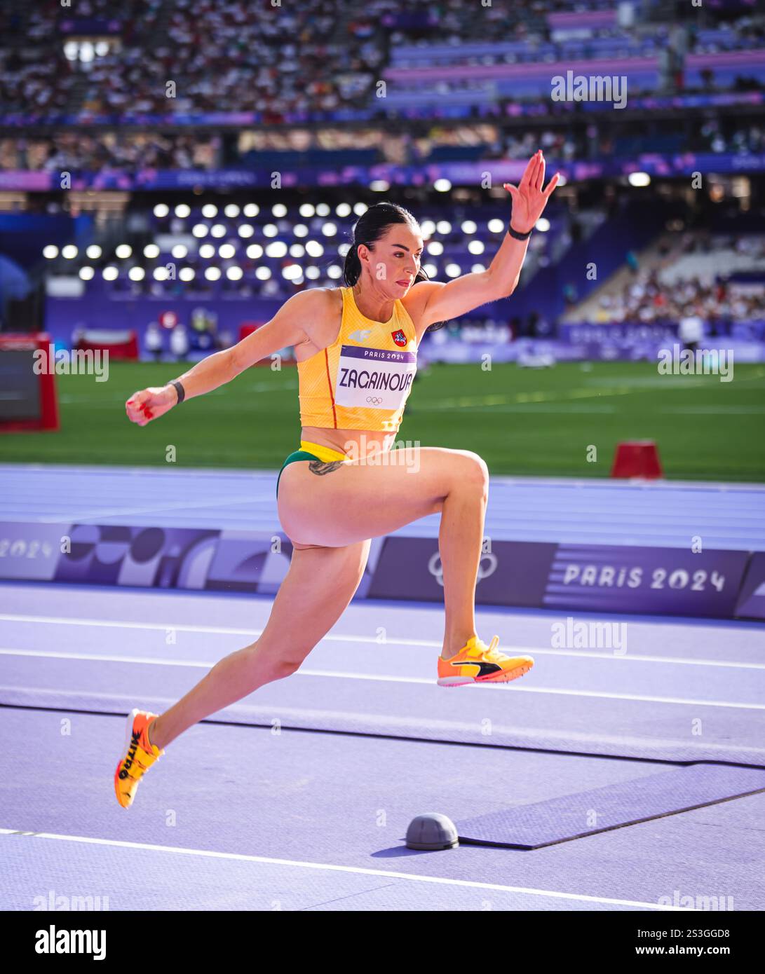 Diana Zagainova celebrating her medal with her country's flag at the ...