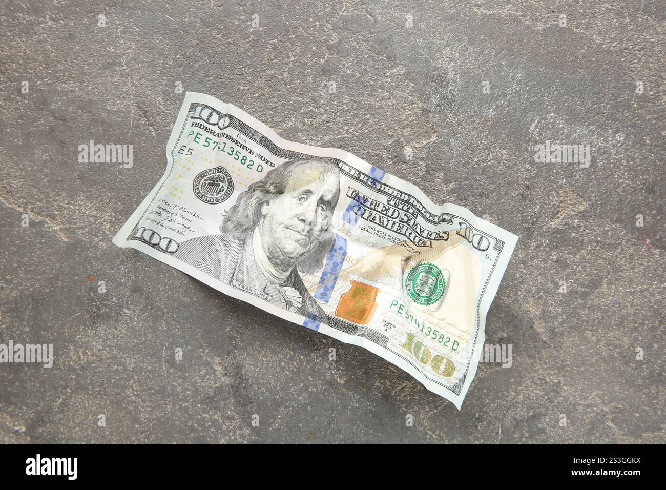 One crumpled dollar banknote on grey table, top view Stock Photo - Alamy
