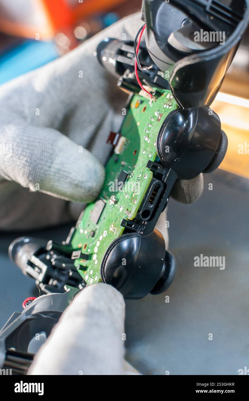 Hand with glove checking an opened video game controller Stock Photo ...