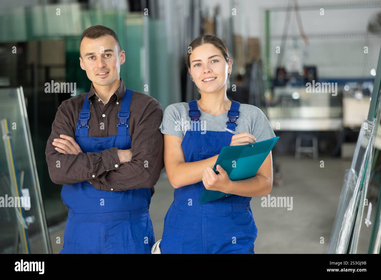 Positive glass factory worker standing in manufacturing facility Stock ...