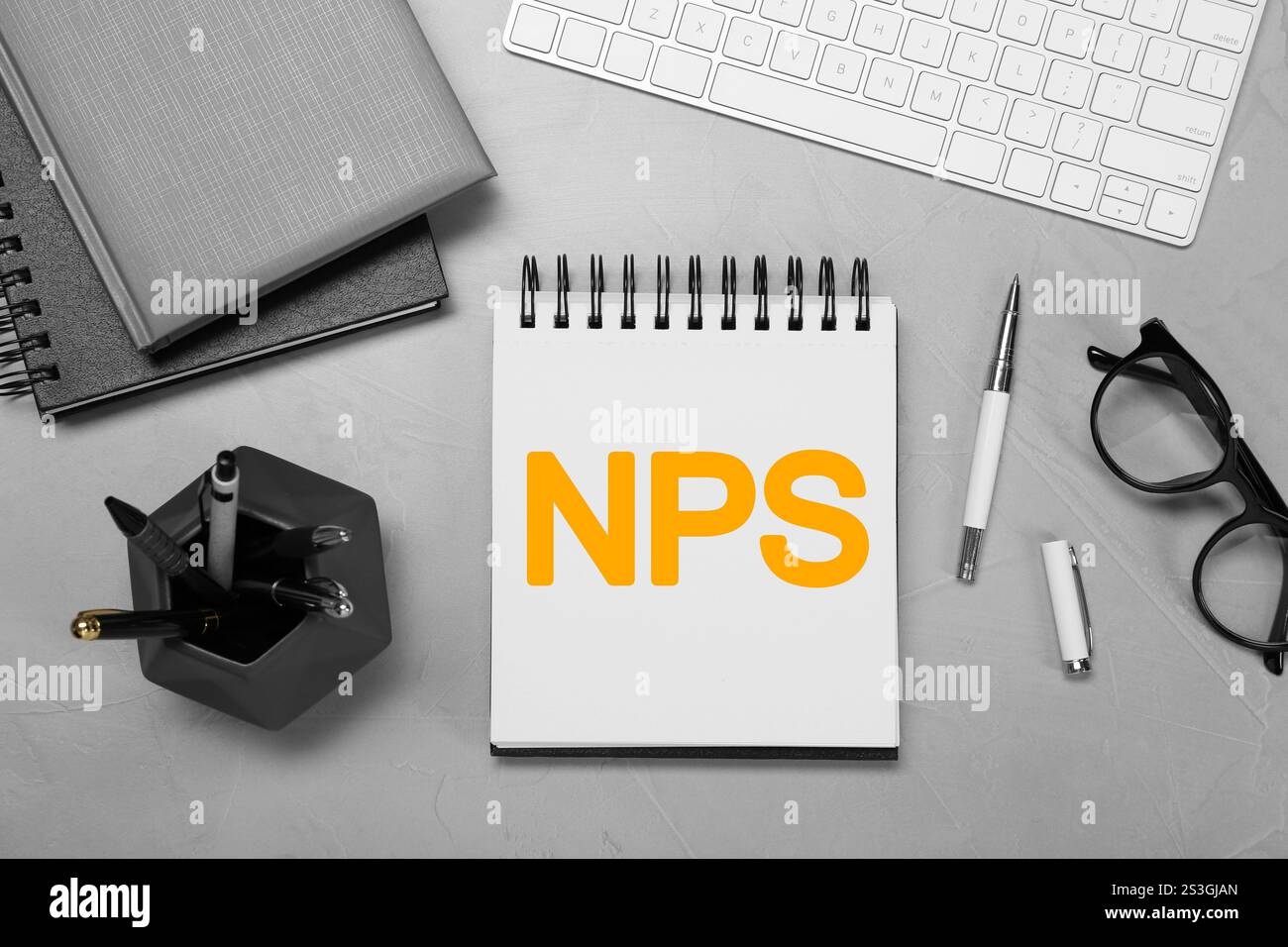 NPS (net promoter score) in notebook on office desk, top view. Customer ...