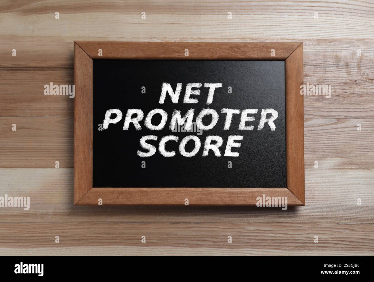 Chalkboard with Net Promoter Score (NPS) on wooden background. Customer ...