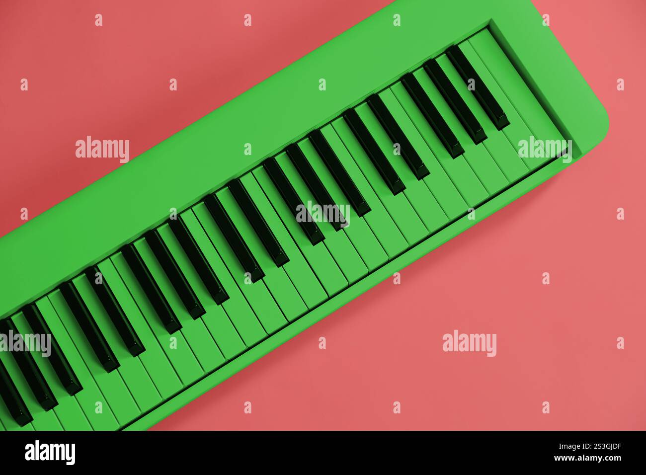 Green synthesizer on pink background, top view. Electronic musical ...