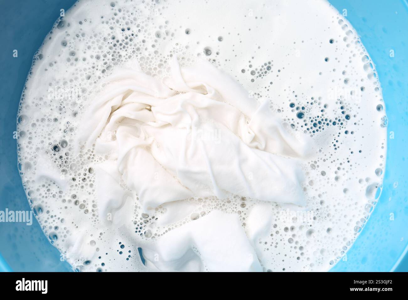 White clothes soaked in water before washing, top view Stock Photo - Alamy