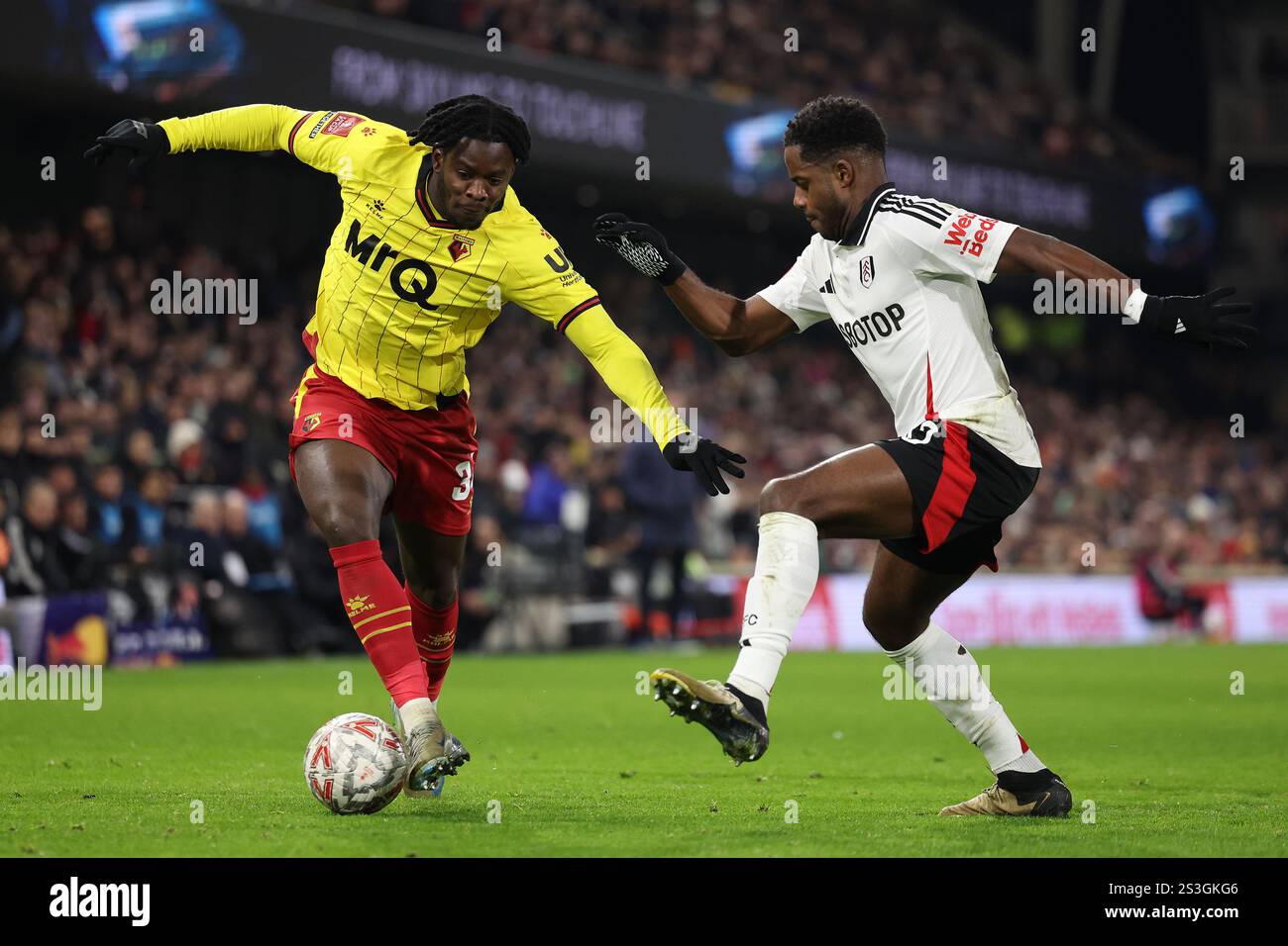 London, UK. 9th Jan, 2025. Kwadwo Baah of Watford and Ryan Sessegnon of Fulham challenge for the ...